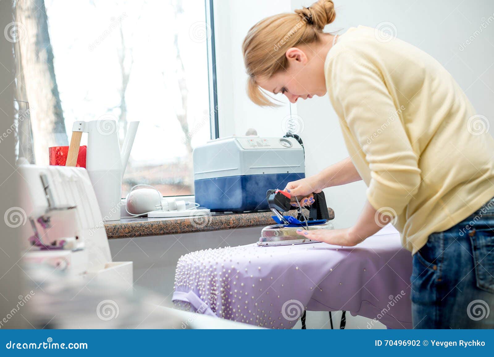 Tailor ironing the fabric. stock photo. Image of haute - 70496902