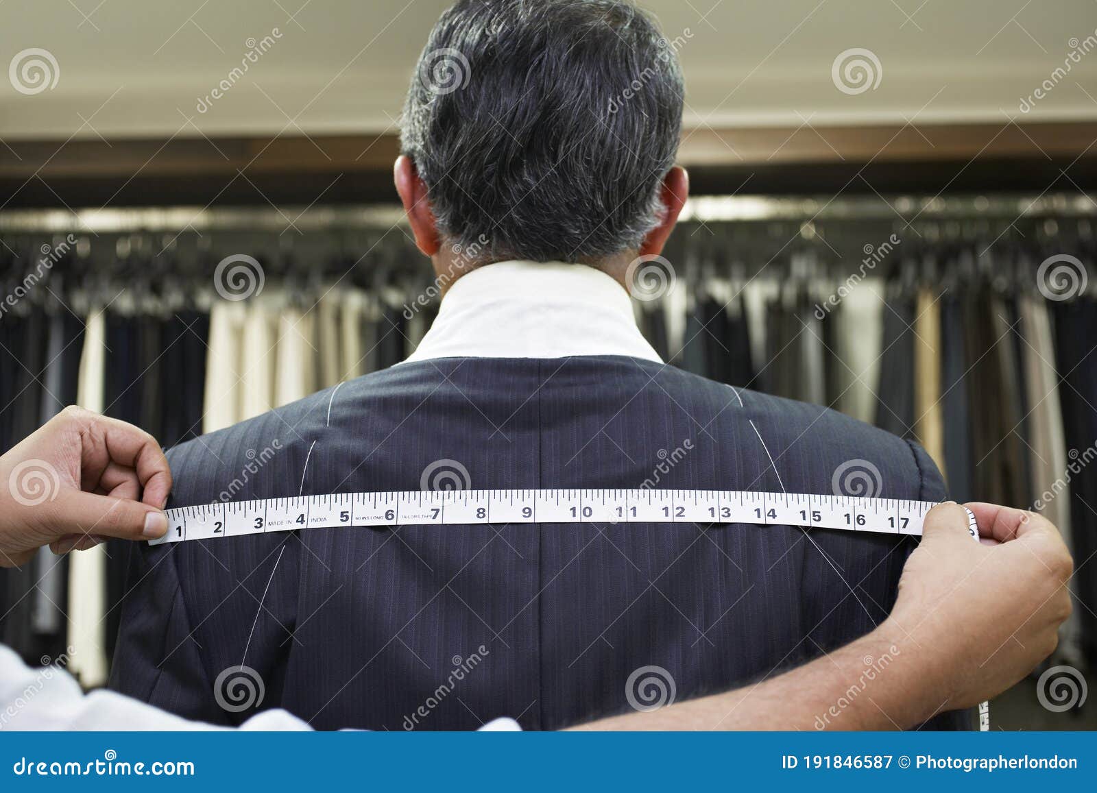 Tailor Fitting Man in Suit stock image. Image of measurements - 191846587