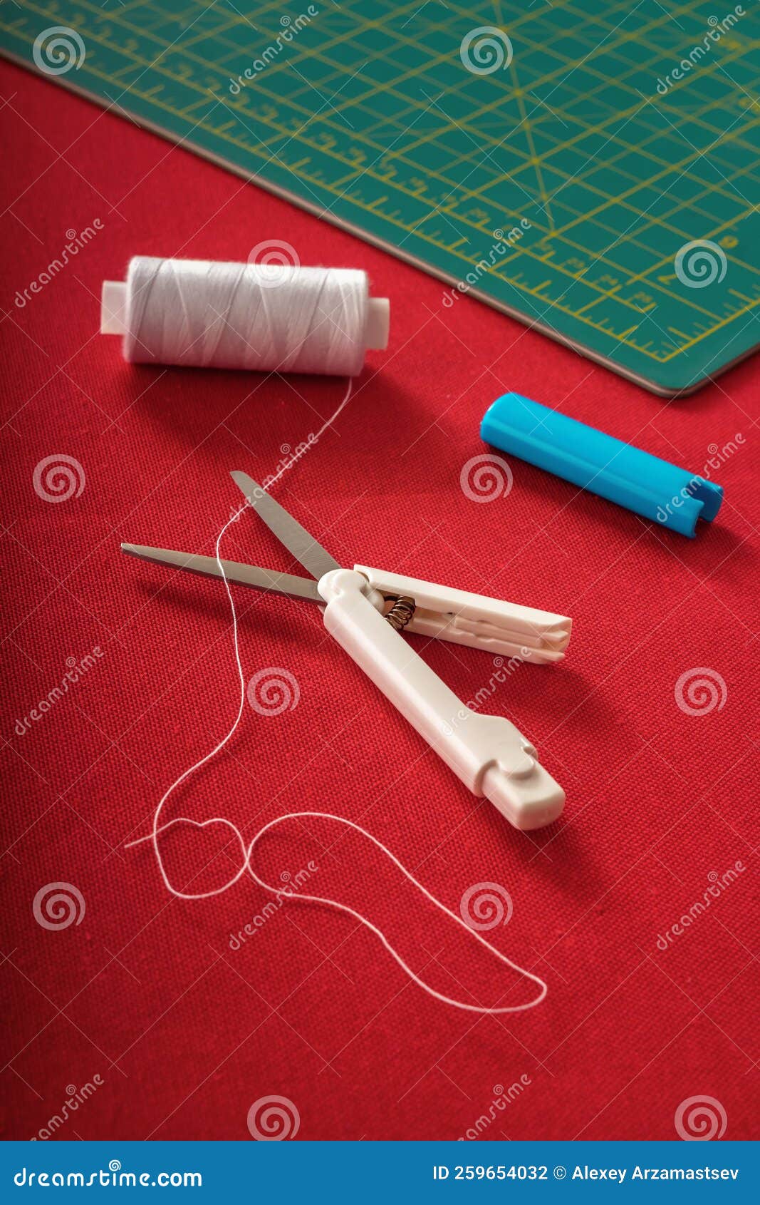 Tailor`s Scissors and Threads Lie on a Fabric Blank Against the ...