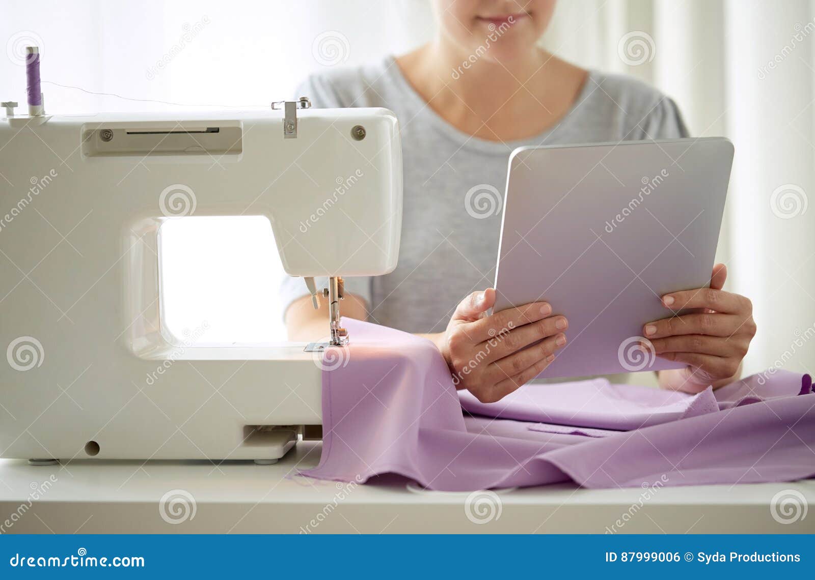 Tailor with Sewing Machine, Tablet Pc and Fabric Stock Photo - Image of ...