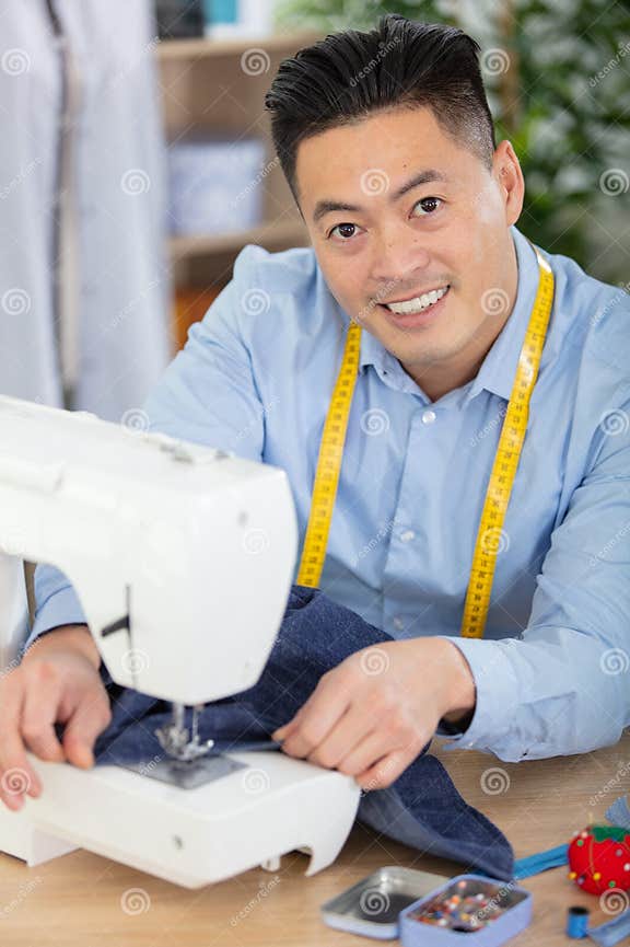 Tailor with Sitting by Sewing Machine at Workshop Stock Photo - Image ...