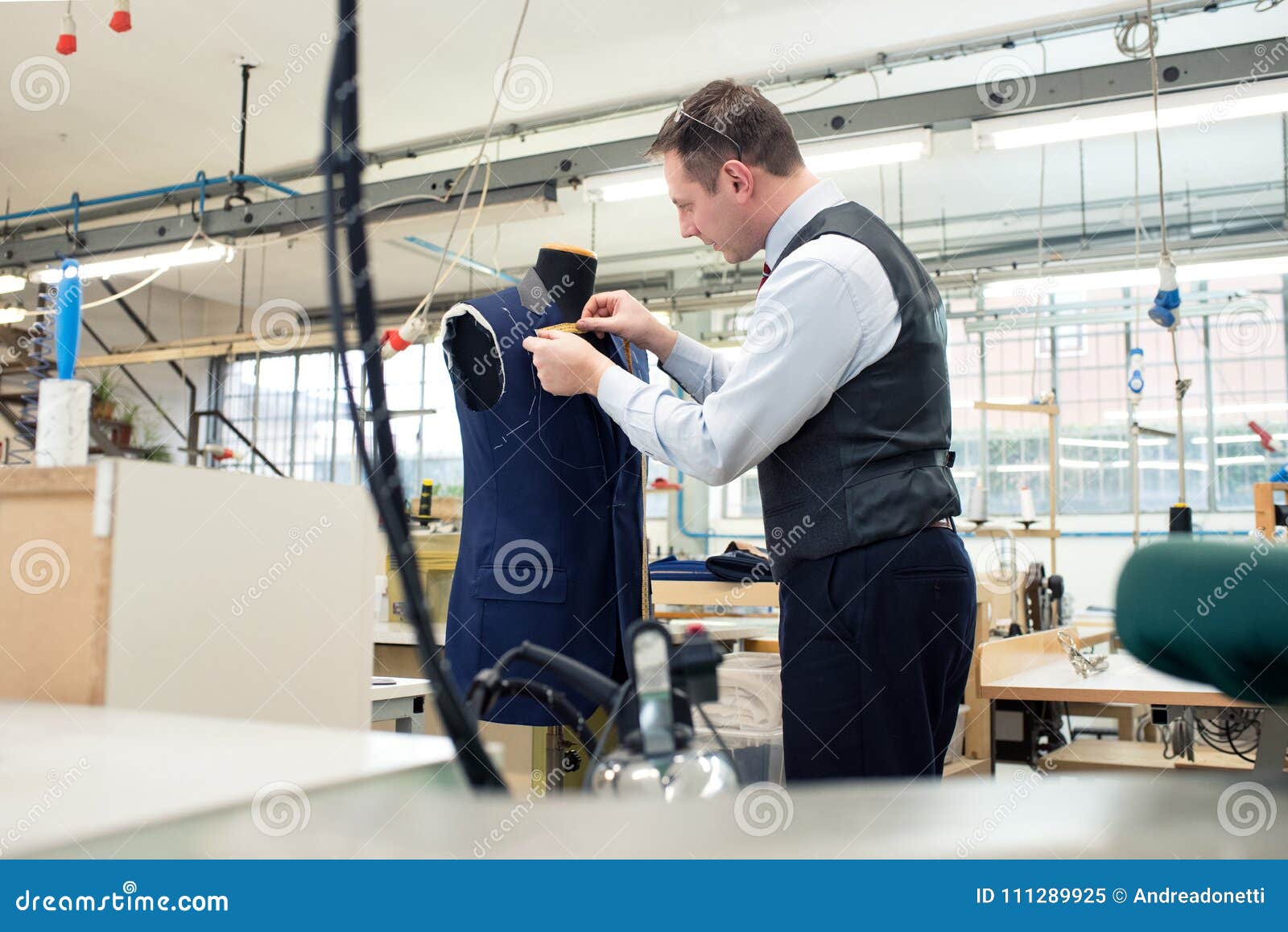 Tailor Standing Working on a Blue Jacket Stock Image - Image of ...