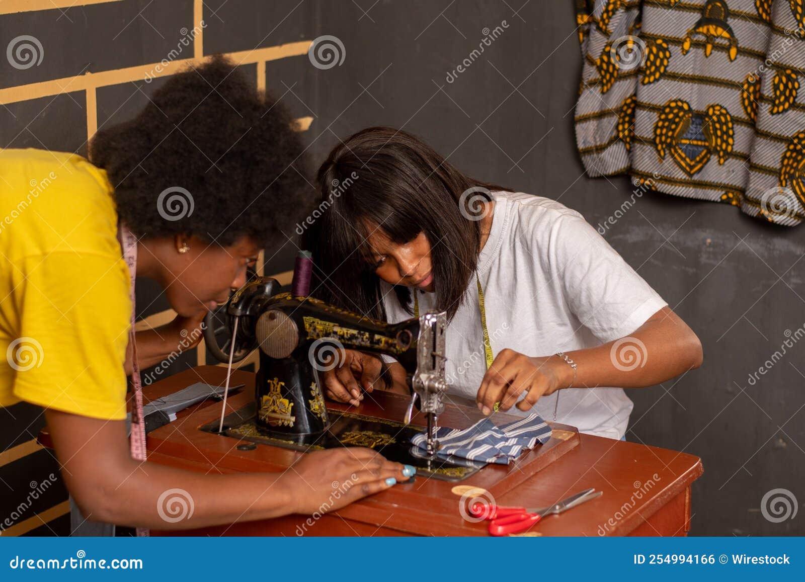 Tailor Teaching an Apprentice Stock Photo - Image of africa, adult ...