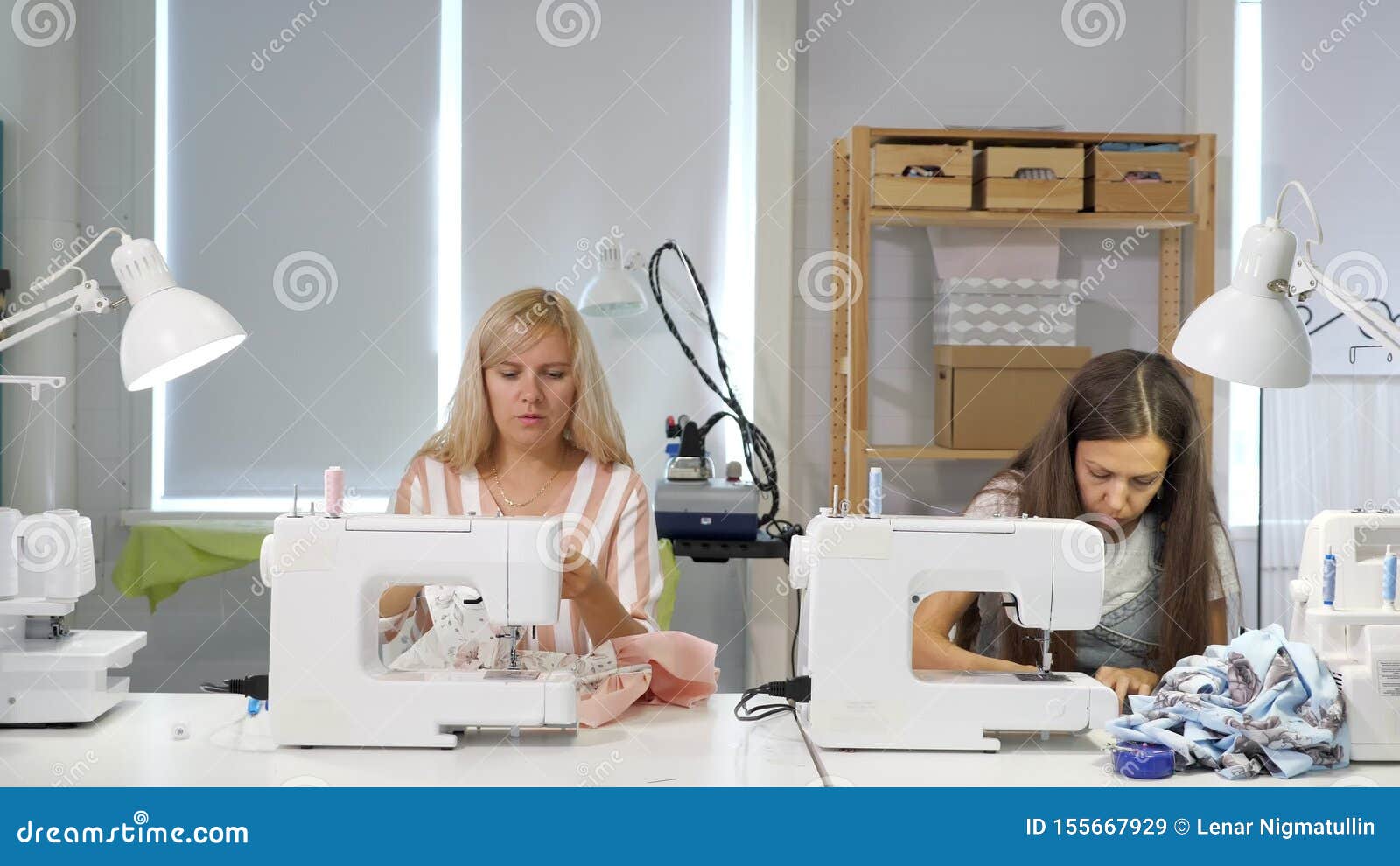 Seamstresses at Work in Workshop Sewing Clothes on Sewing Machine, Side ...