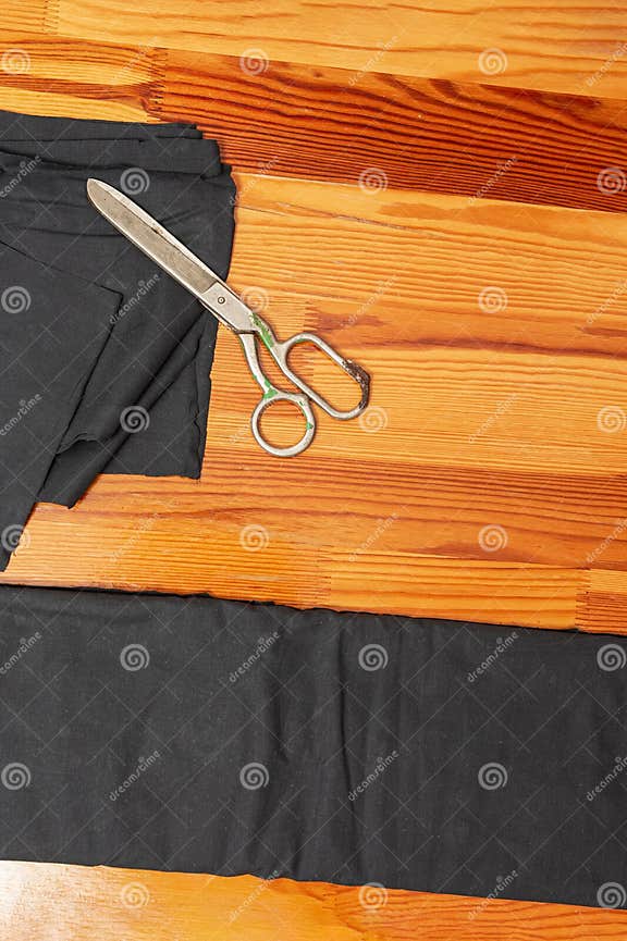 Tailoring Concepts. Cutting Textile Cloth at Work Table with Old Rusty Scissors and Black Fabric ...