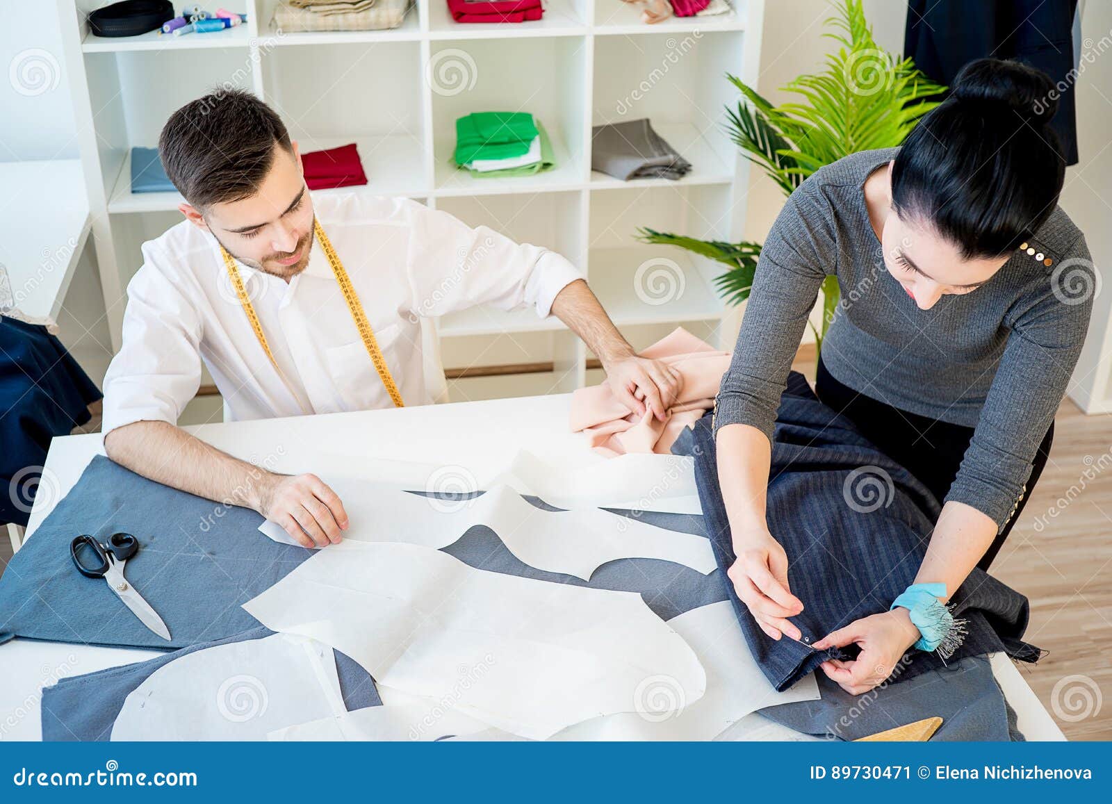 Tailors working on clothes stock image. Image of female - 89730471