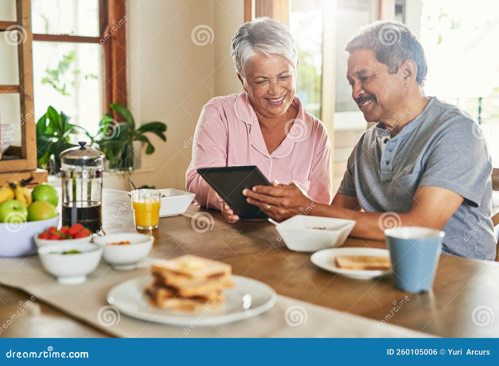 Take a Look at this Dear. a Cheerful Elderly Couple Browsing on a ...