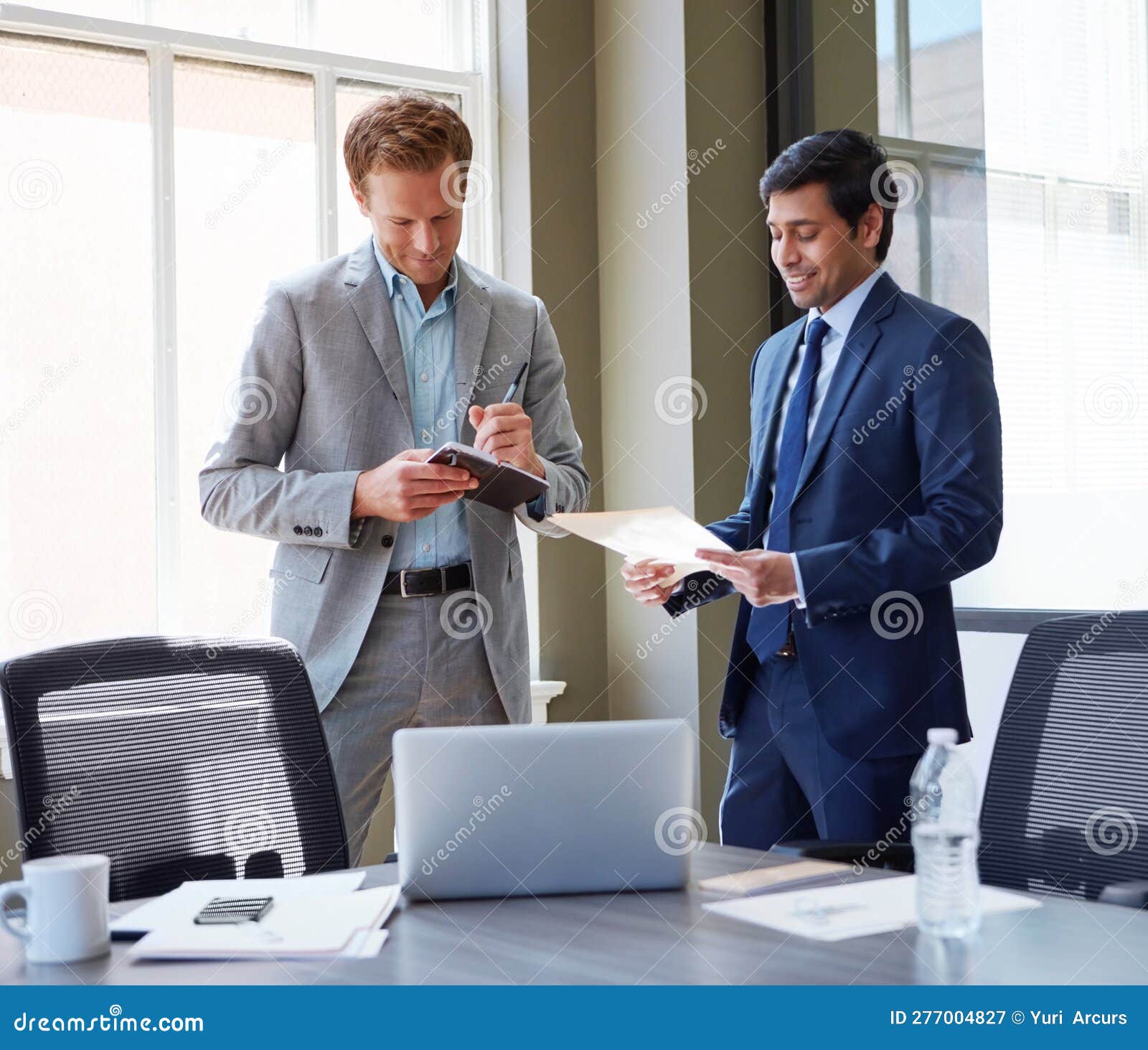 Take a Look at these Figures. Businessmen Looking at Paperwork in Their ...