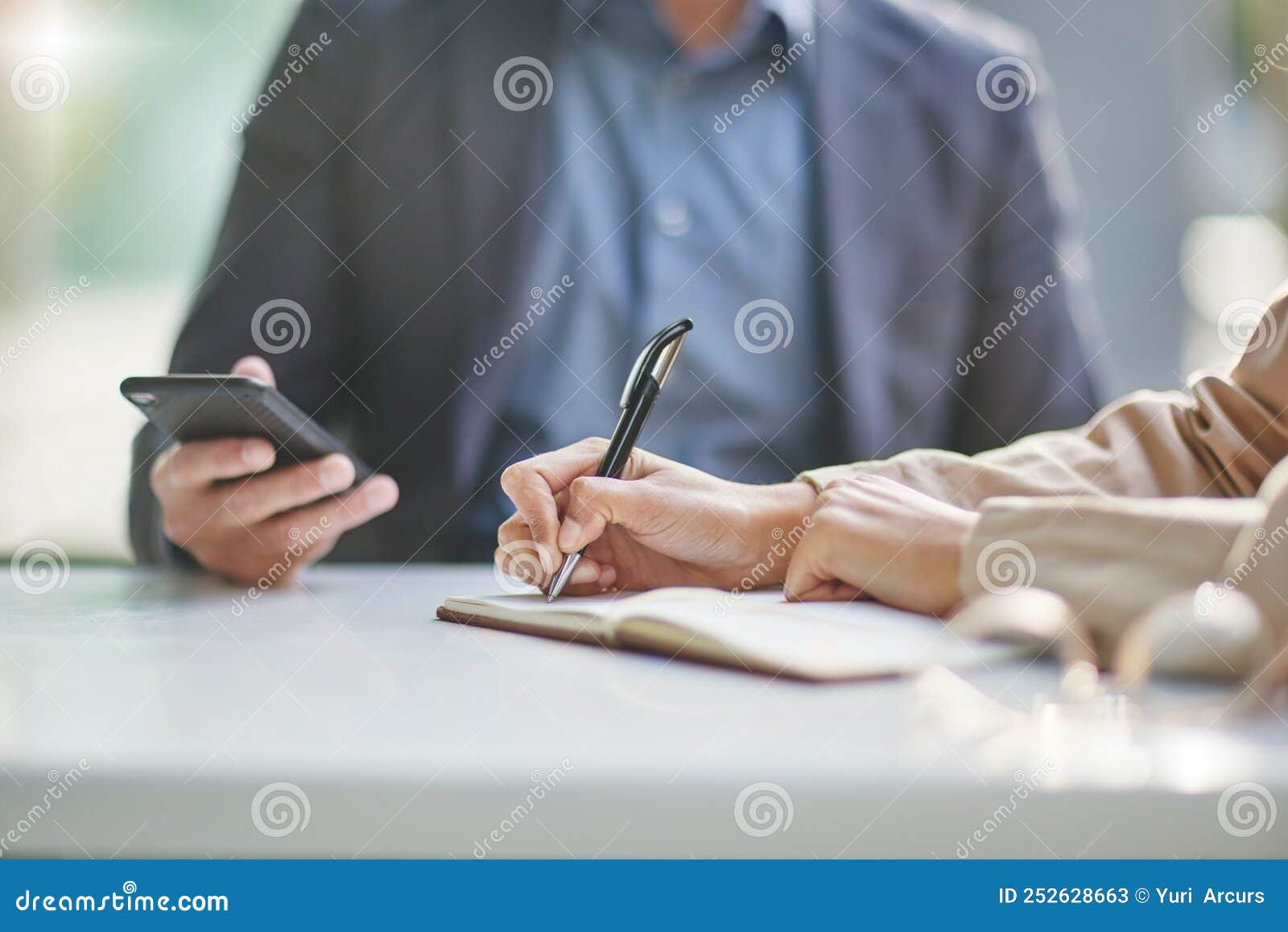 Take these Notes Down. Two Work Colleagues Having a Meeting at a Cafe ...