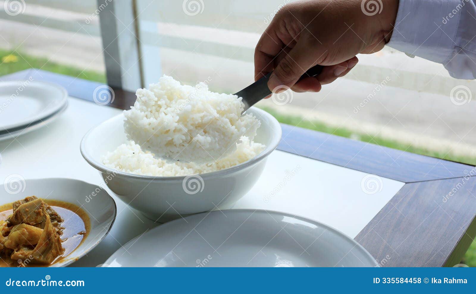 Take a Portion of Rice To the Plate, Scooping Steamed Rice Stock Photo ...