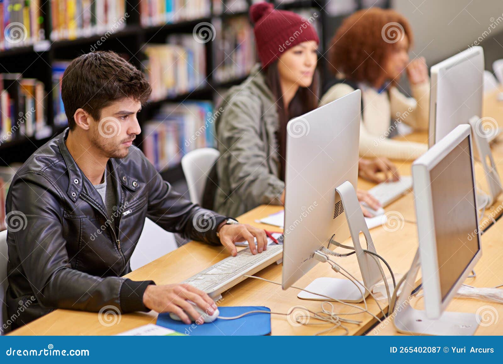 He Takes His Studies Seriously. Students Working on Computers in a ...