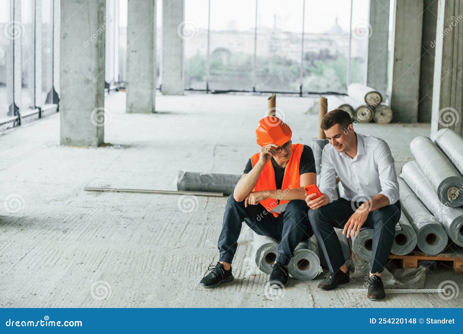 Taking a Break. Man in Suit and Handyman in Orange Protective Wear is ...