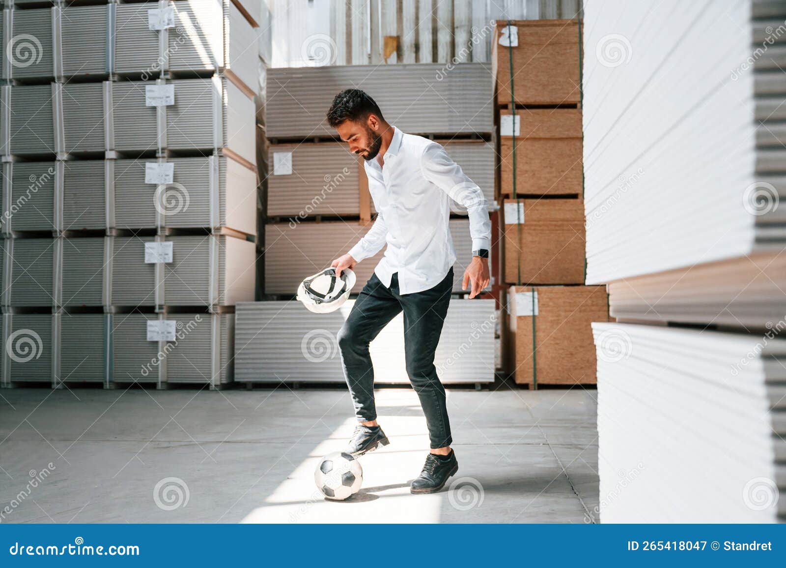 Taking a Break, Playing with Soccer Ball. Storage Worker is in the ...