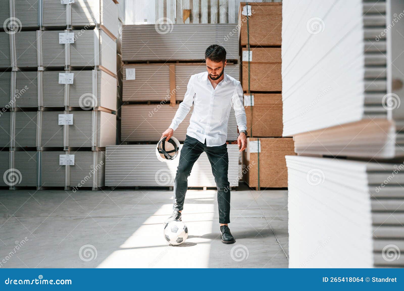 Taking a Break, Playing with Soccer Ball. Storage Worker is in the ...