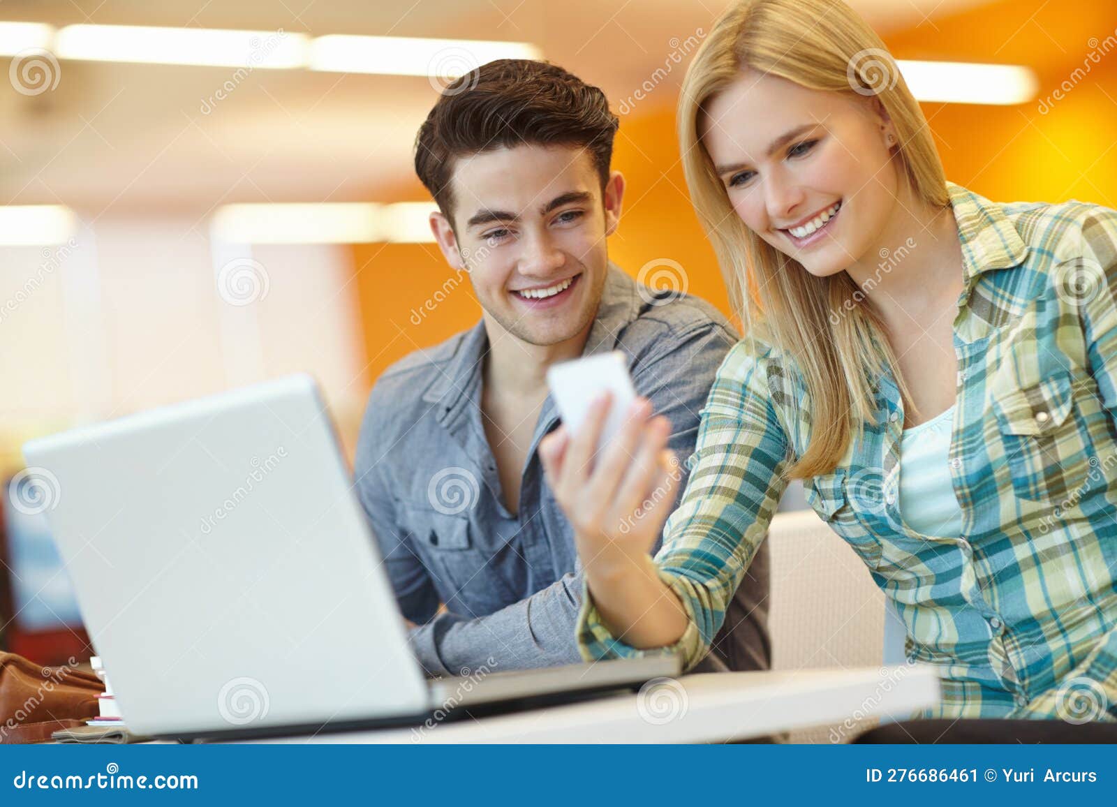 Taking a Break from Their Studies. Two Smiling Students Reading a Funny ...