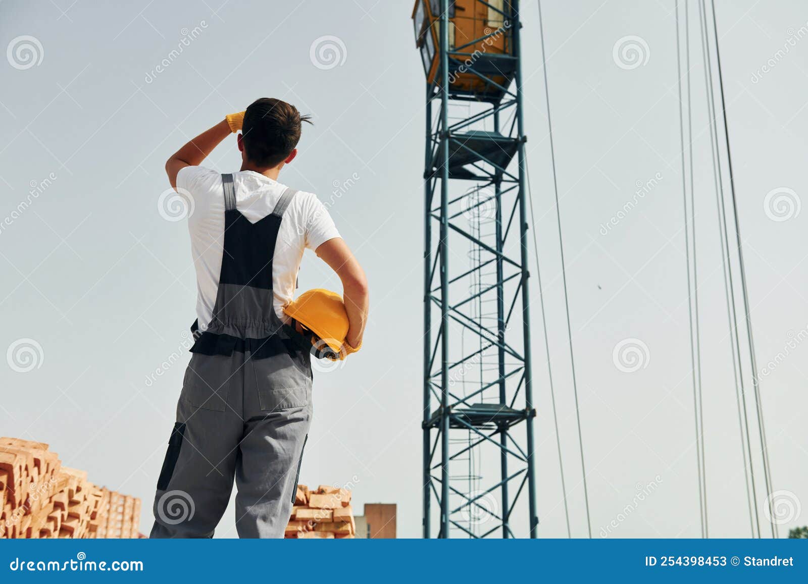 Taking a Break. Young Construction Worker in Uniform is Busy at the ...