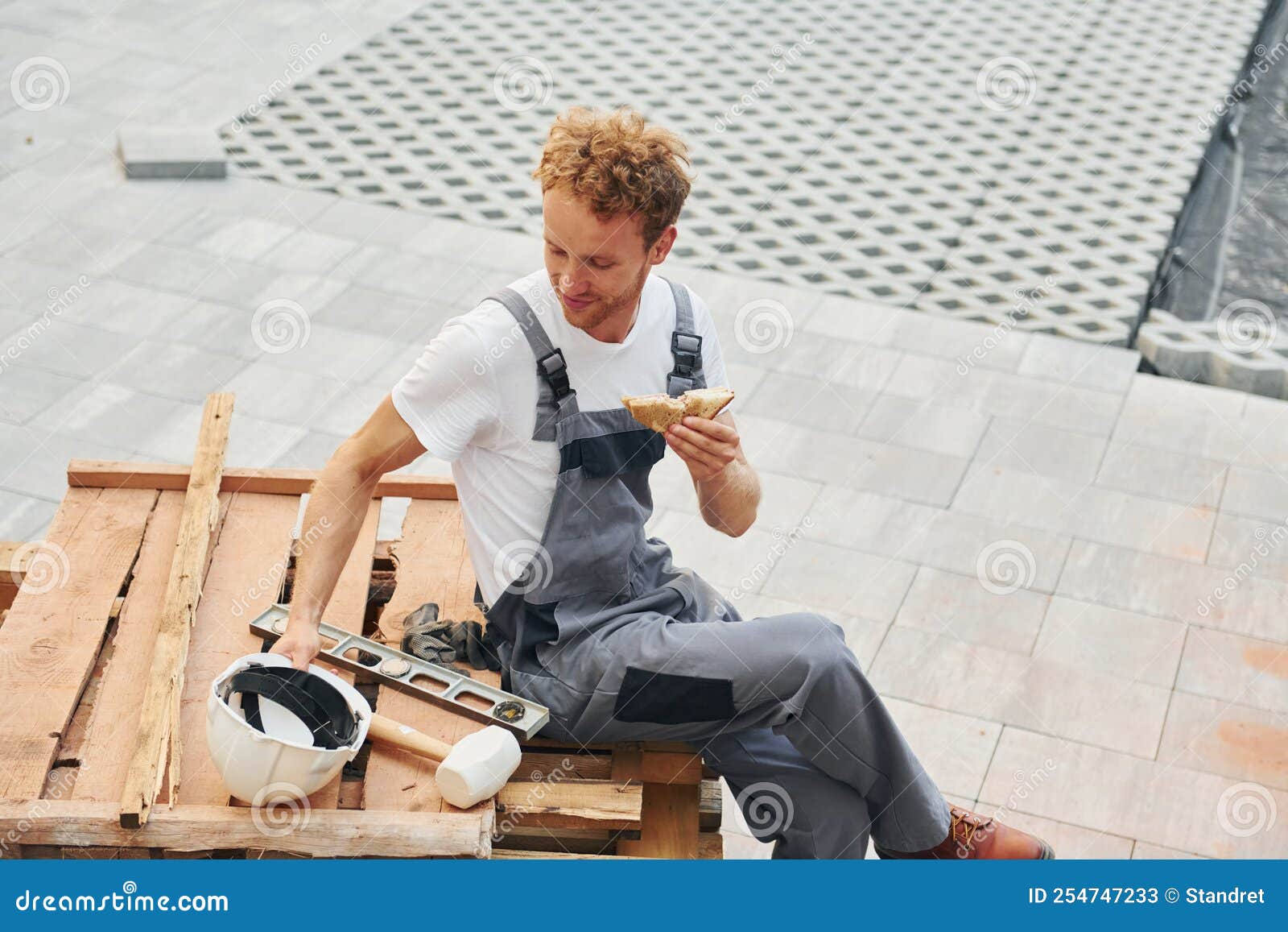 Taking a Break. Young Man Working in Uniform at Construction at Daytime ...