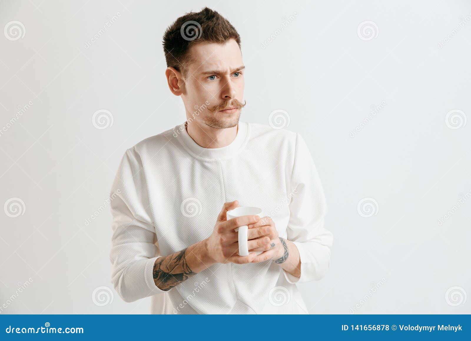 Taking a Coffee Break. Handsome Young Man Holding Coffee Cup while ...