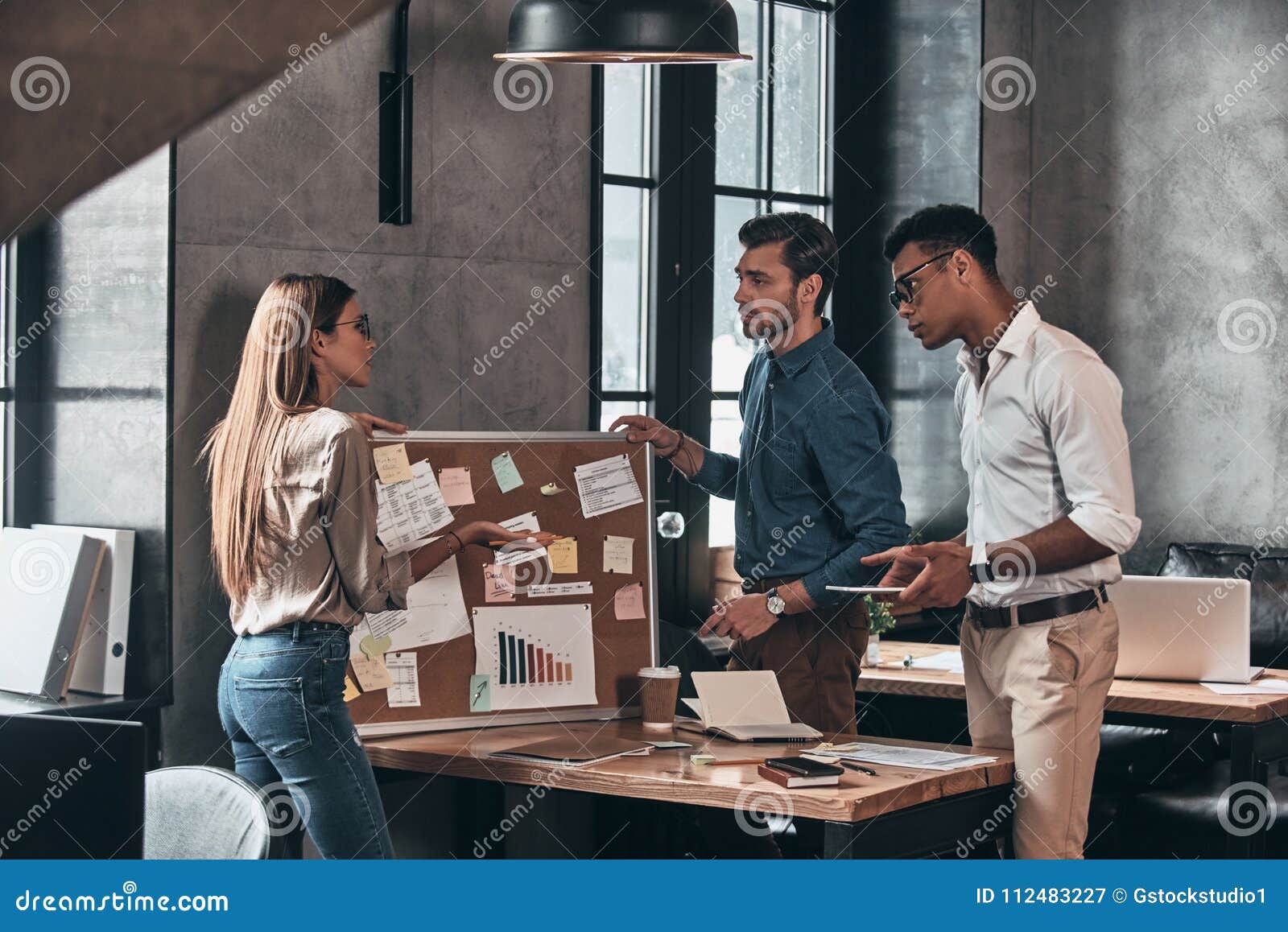 Taking Important Decision. Group of Young Business People Using Stock ...