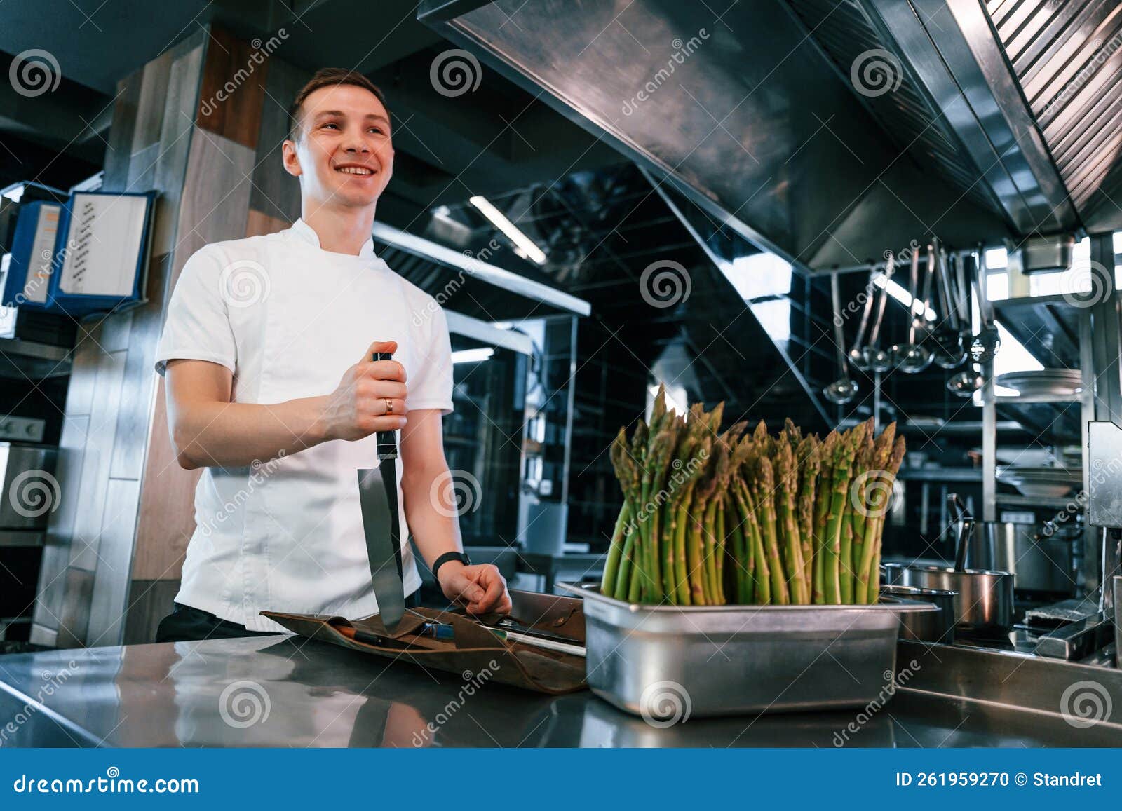 Taking the Knife. Chef is on the Kitchen Preparing Food Stock Photo ...
