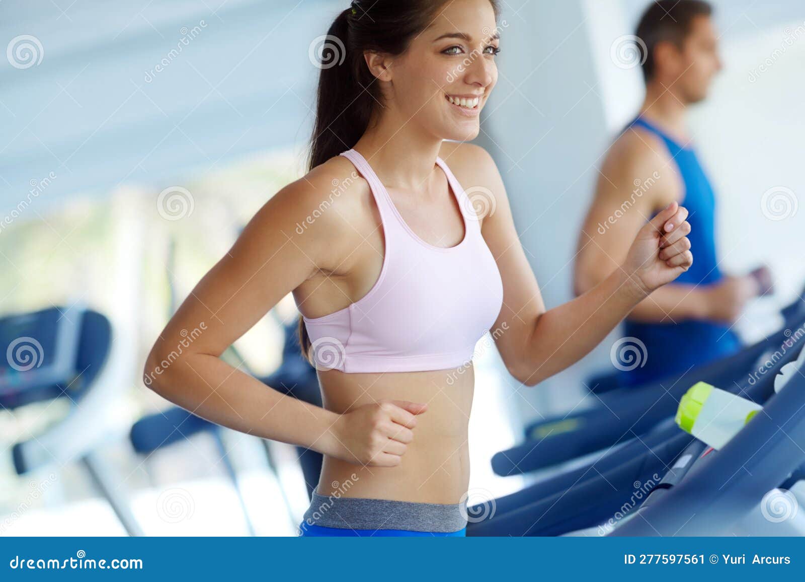 Taking the Next Step To Fitness. a Young Man and Woman Exercising on ... Taking the Next Step To Fitness. a Young Man and Woman Exercising on ...