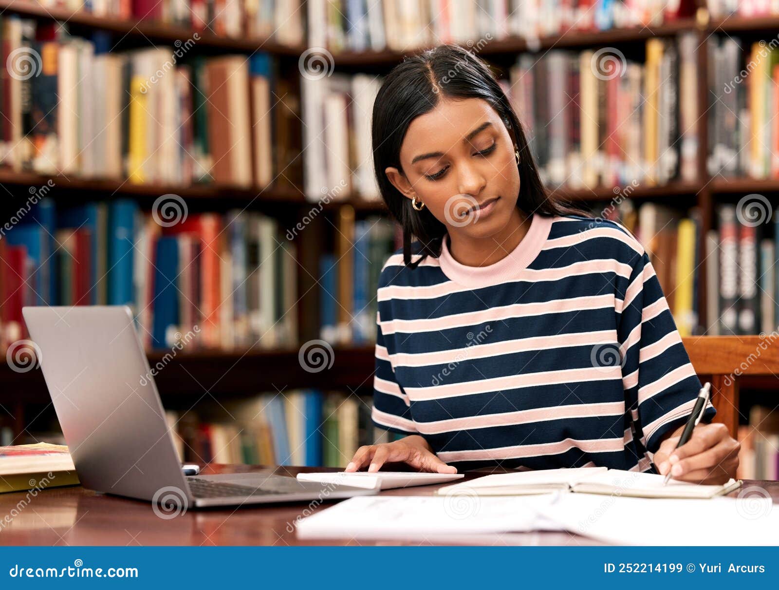 Taking Notes Makes Revising Easier. a Young Female Student Studying in ...