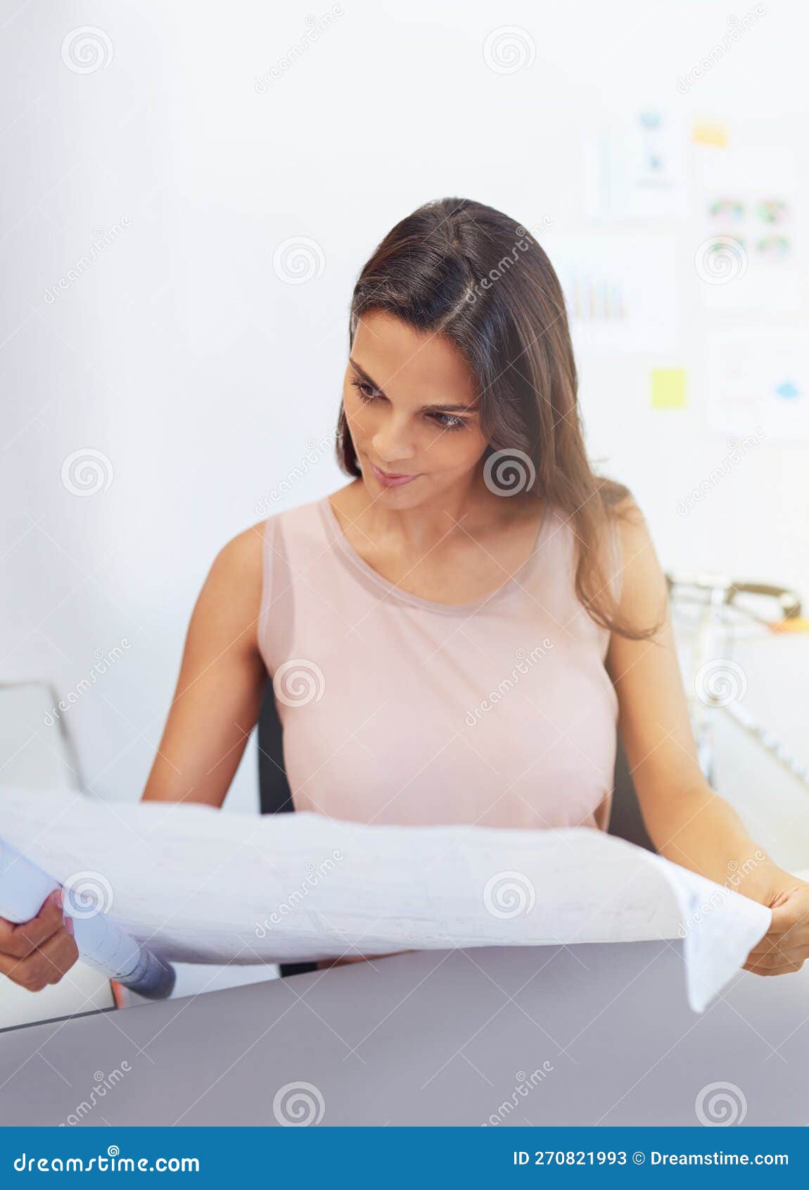 Taking a Quick Look Over the Plans. a Young Architect Looking Over Some ...