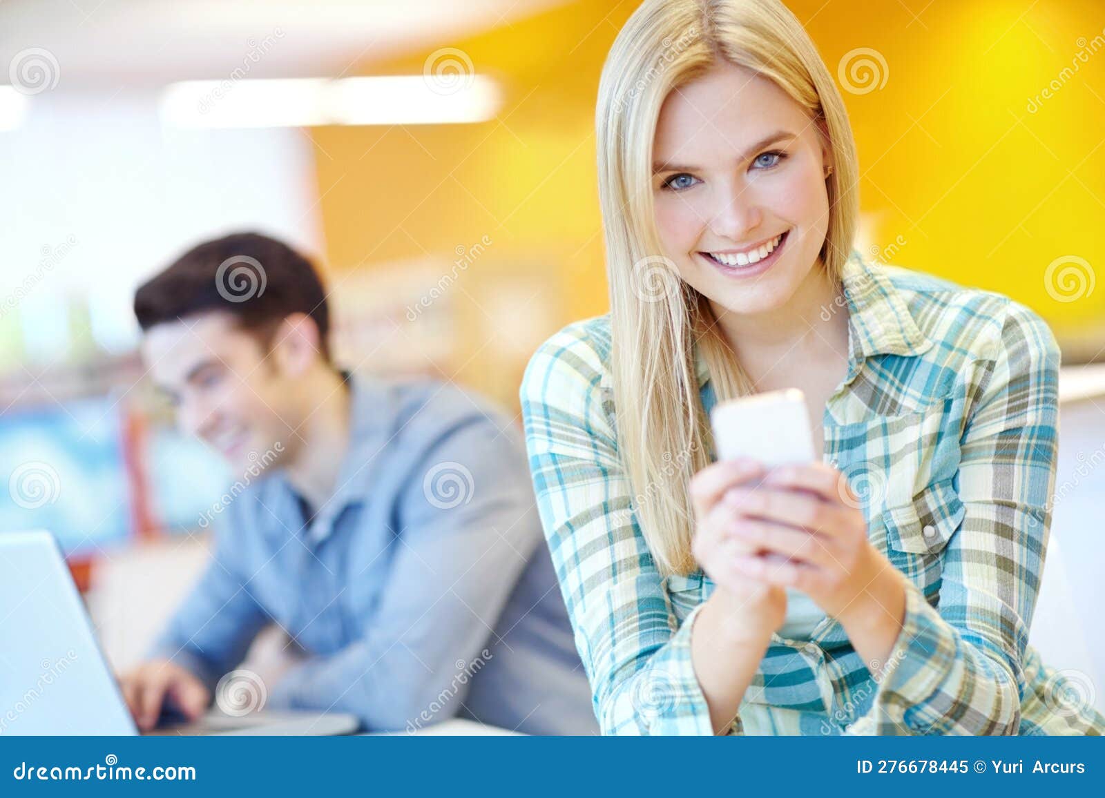Taking a Quick Study Break. Attractive Female Student Reading a Text with Her Study Buddy in the ...