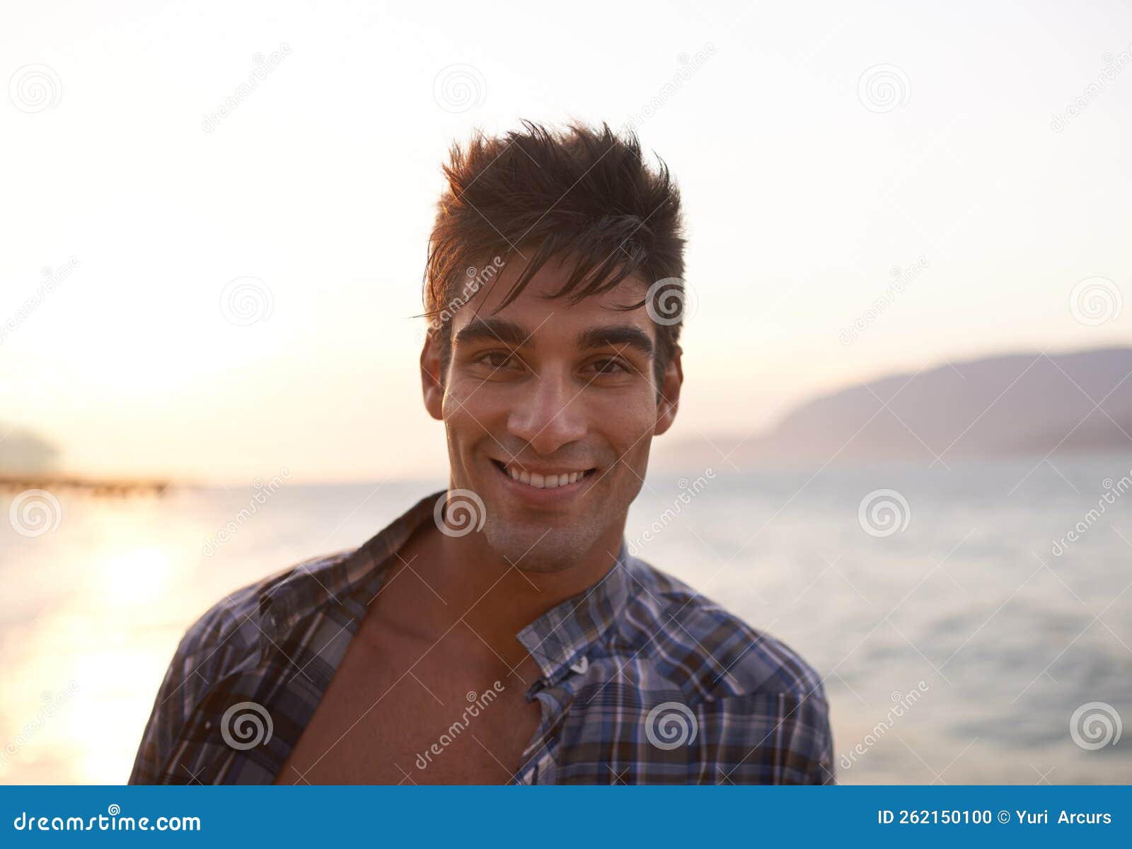 Taking Some Time Off at the Beach. a Handsome Young Man on the Beach ...