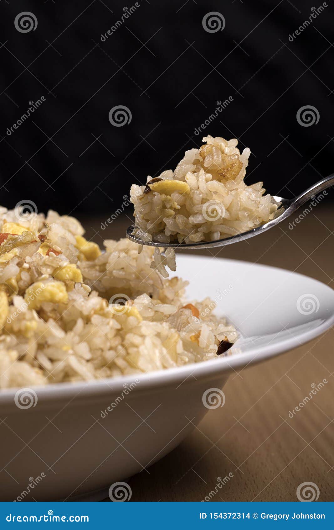 Taking a Spoonful of Fried Rice Stock Photo - Image of dinner, plate ...