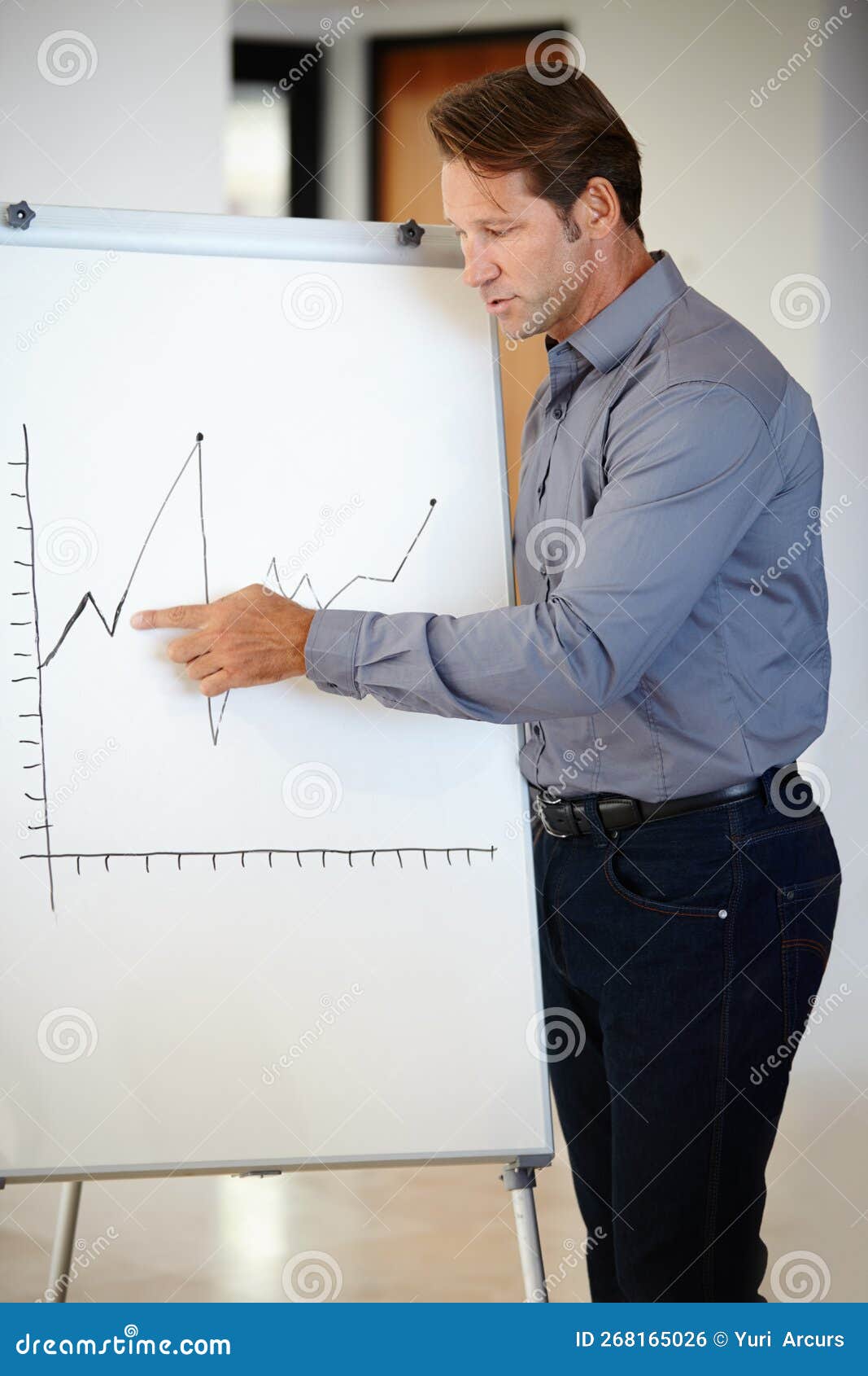 Taking Them through the Graphic. a Man Doing a Presentation with a ...