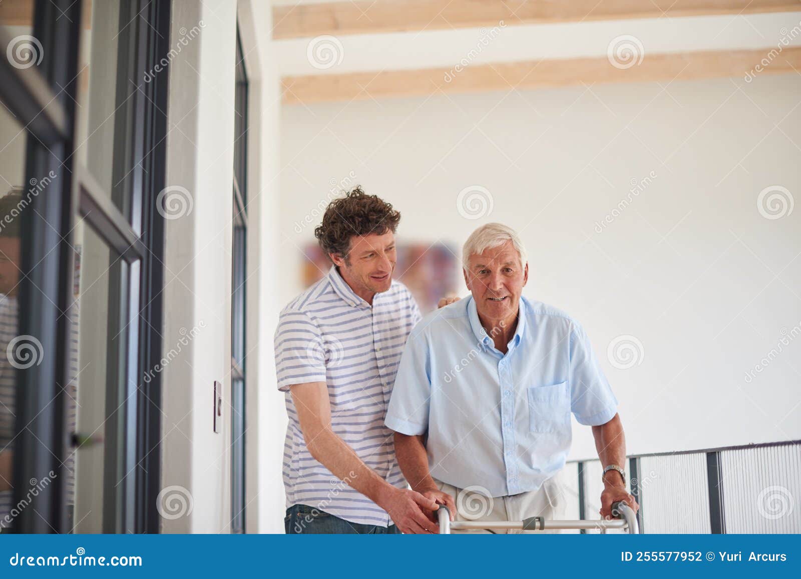 Taking Things Step by Step. a Man Assisting His Elderly Father with an ...