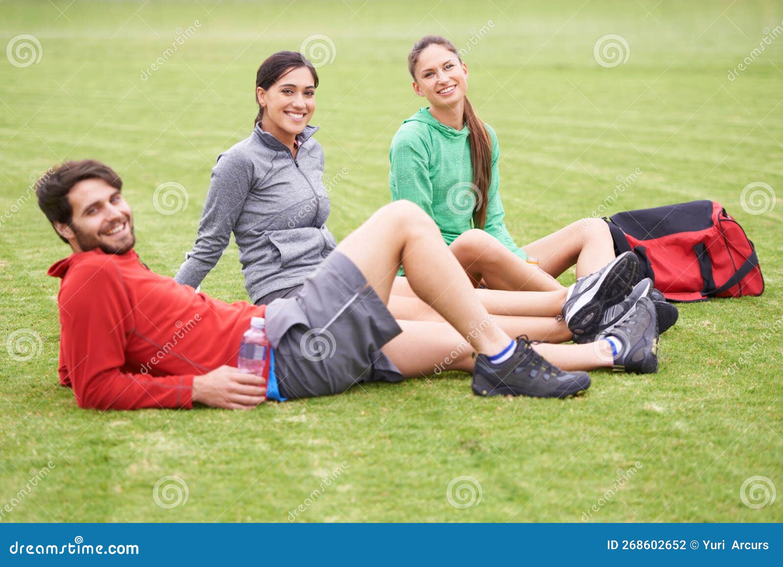 Taking a Timeout. a Group of Young People Relaxing on the Grass after ...
