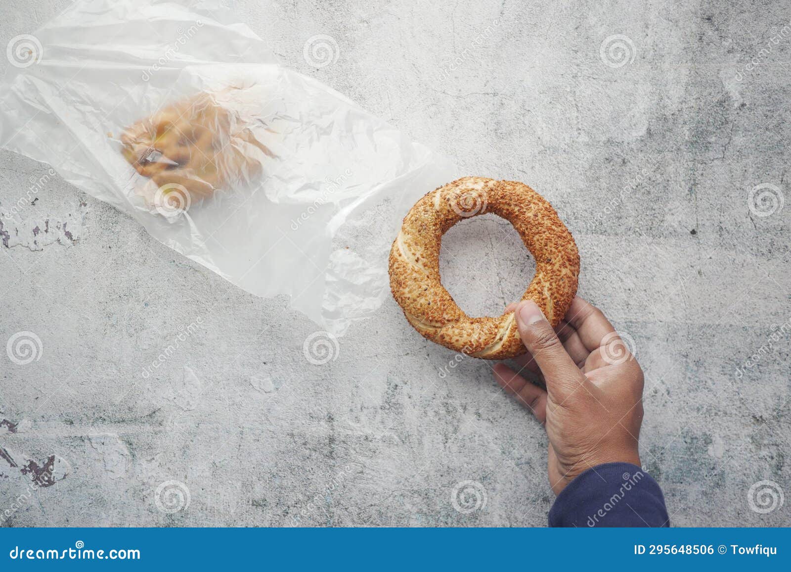 Taking a Turkish Bagel Simit Out from a Plastic Packet Stock Photo ...