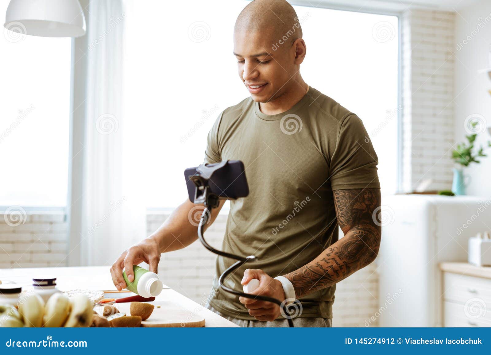 Bald Bodybuilder Taking Vitamins while Cooking Breakfast Stock Photo ...