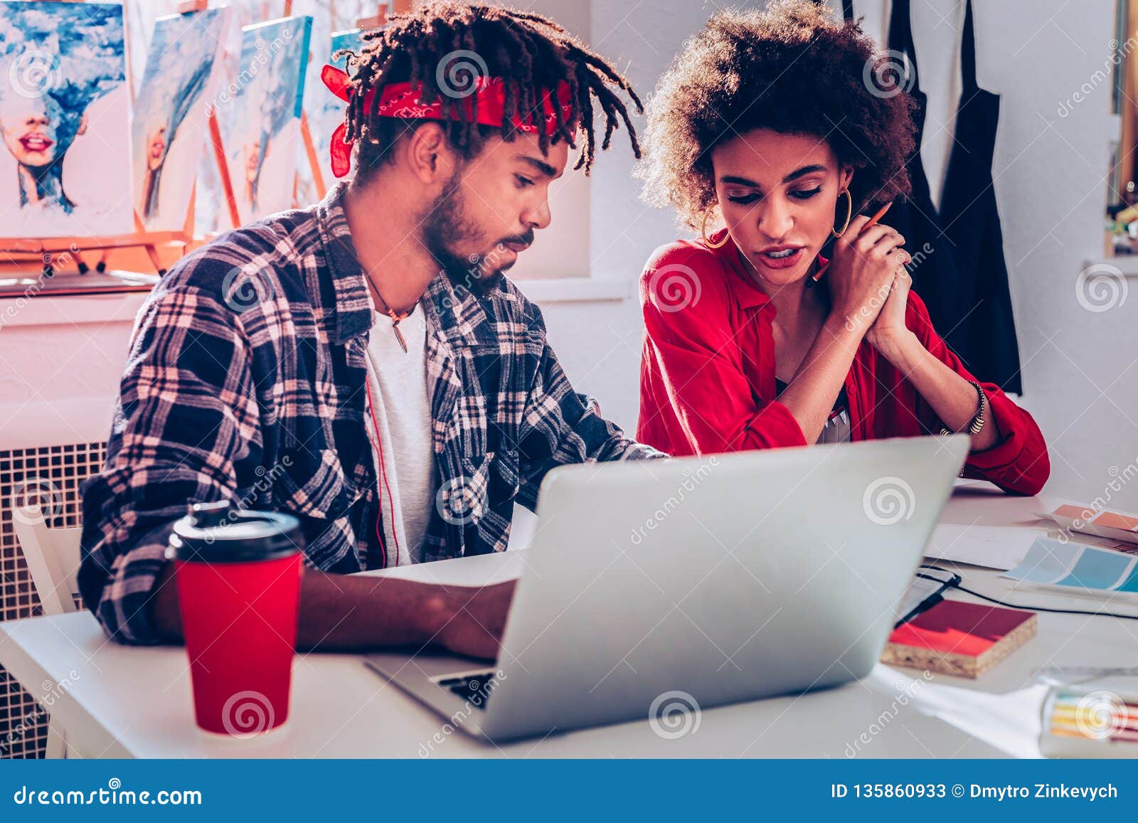 Talented Creative Couple Sitting in Front of Laptop Working Together ...