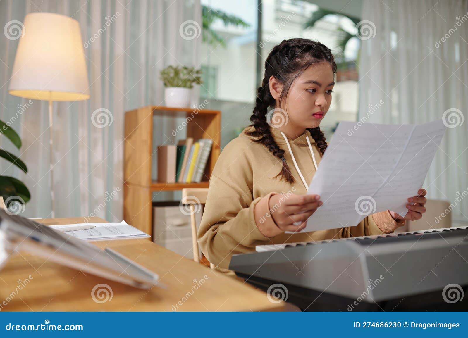 Girl Reading Music Notes stock photo. Image of desk - 274686230