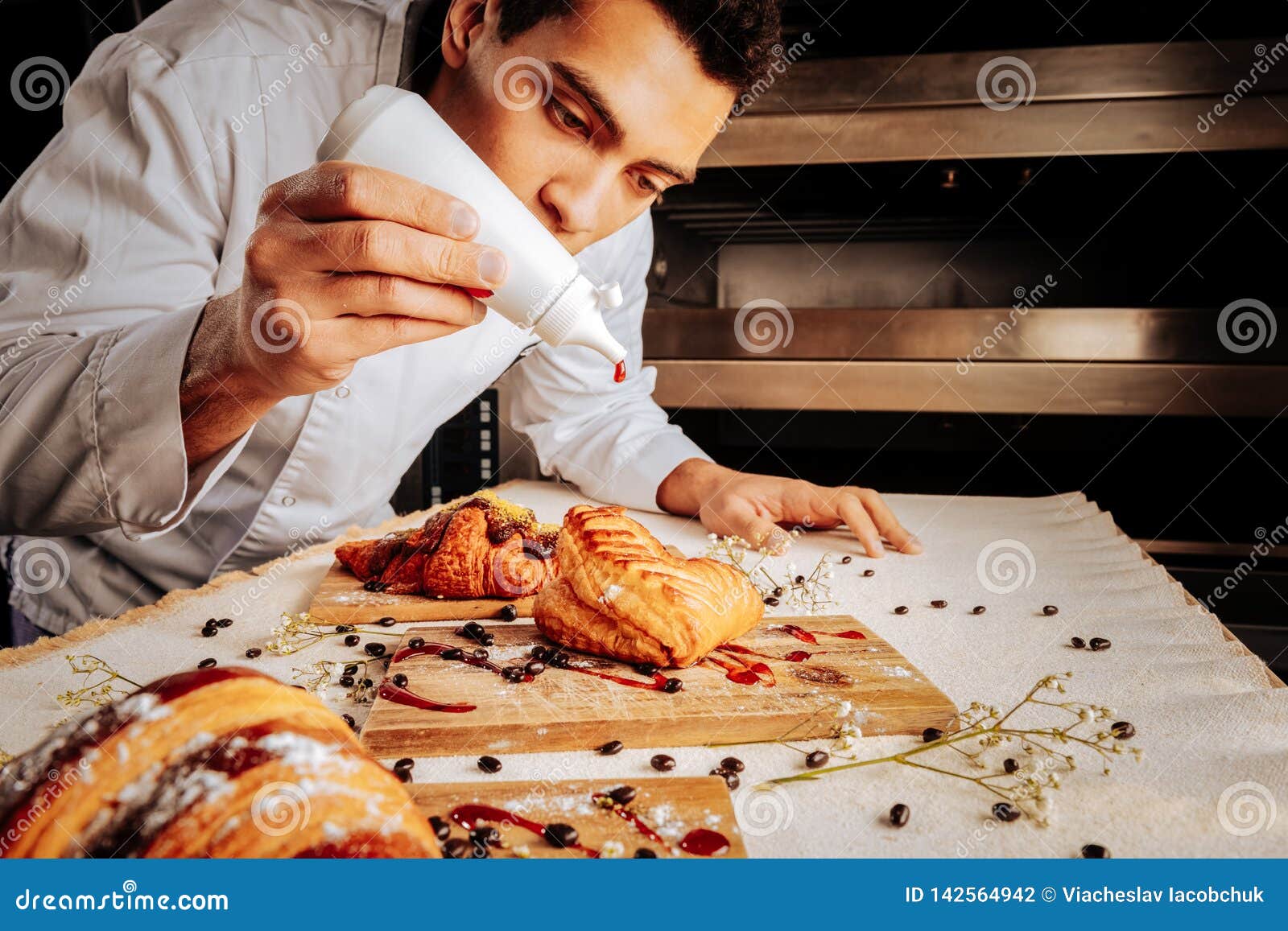 Talented Inspired Baker Using Strawberry Topping for Cream Puff Stock ...