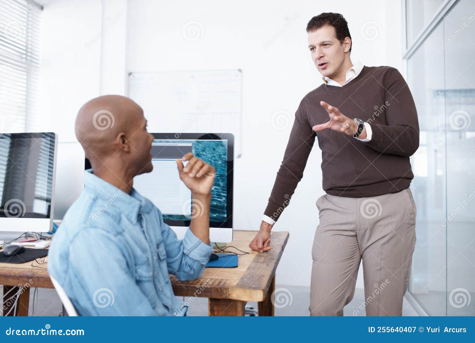 Talking Business Strategies. Two Businessmen Talking in the Office ...