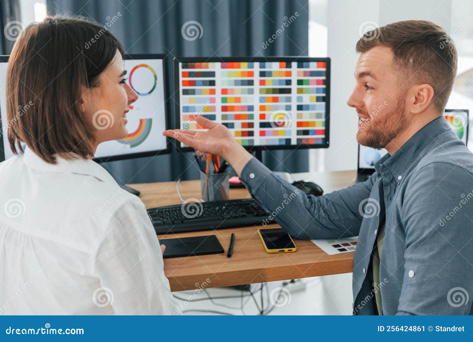 Talking and Creating Content. Two Designers Working Together in the ...