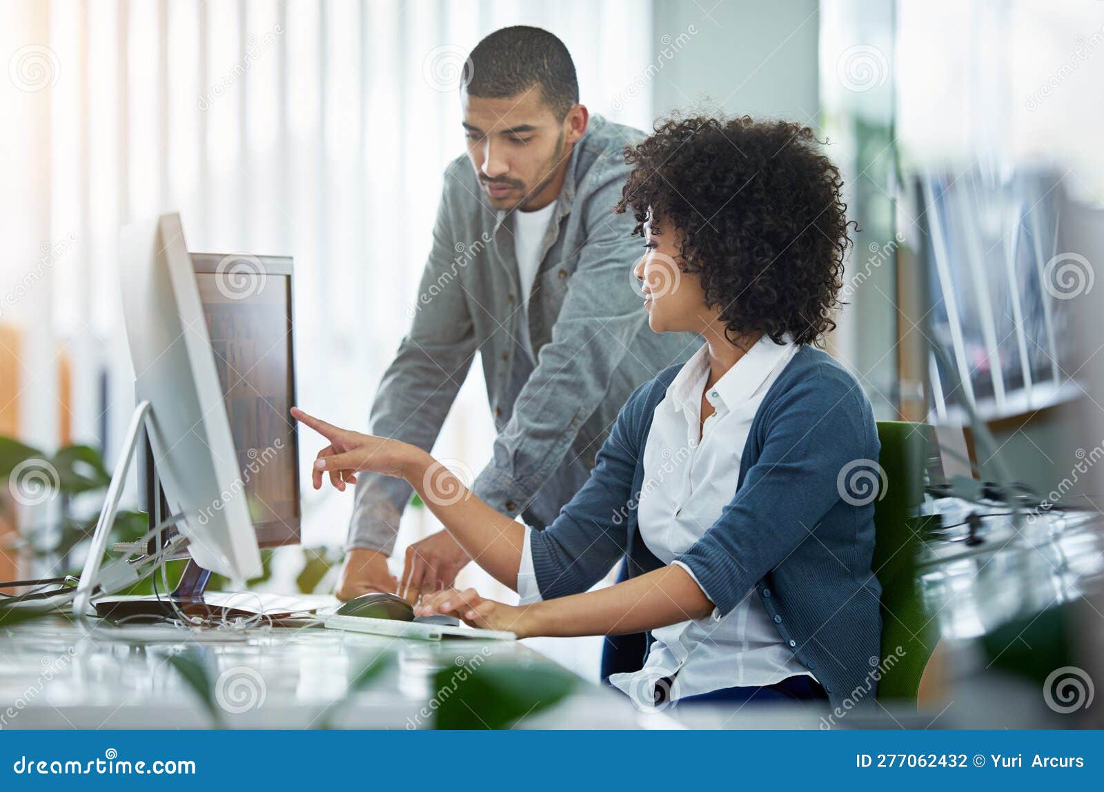 Talking Design in the Office. Two Young Designers Talking Together ...