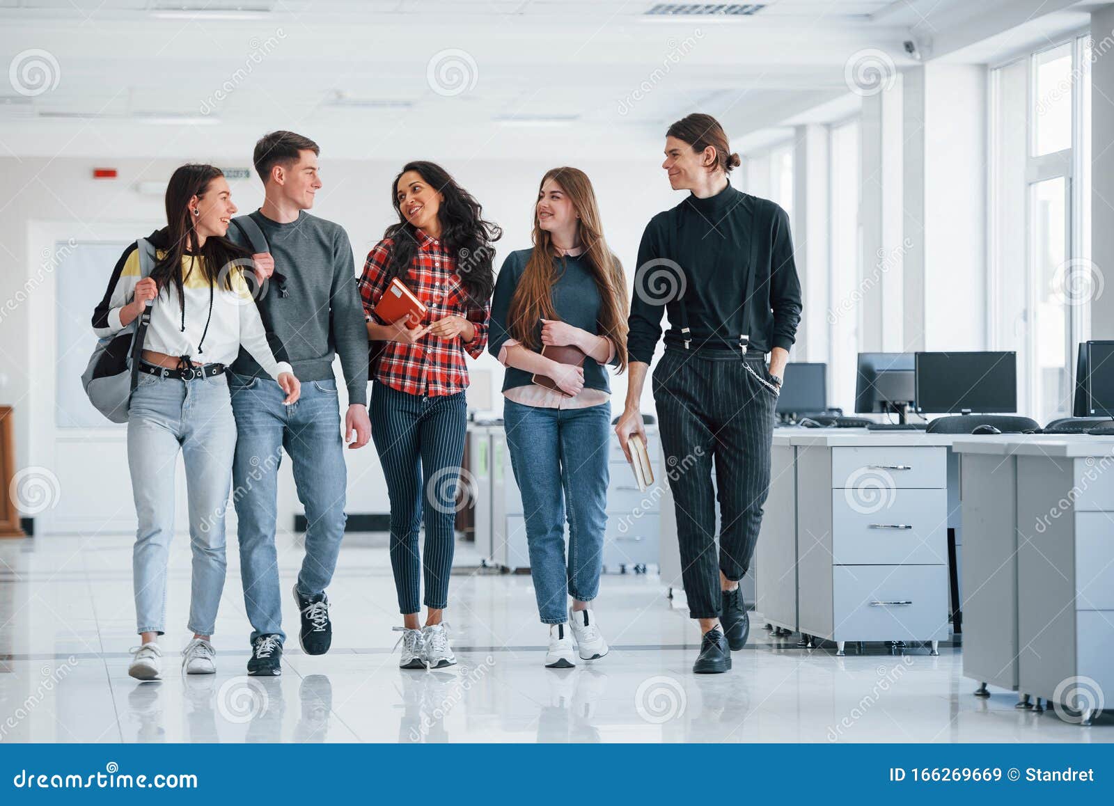 Talking with Each Other. Group of Young People Walking in the Office at ...