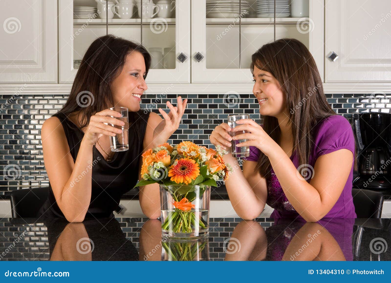 Talking in the kitchen stock photo. Image of girl, kitchen - 13404310