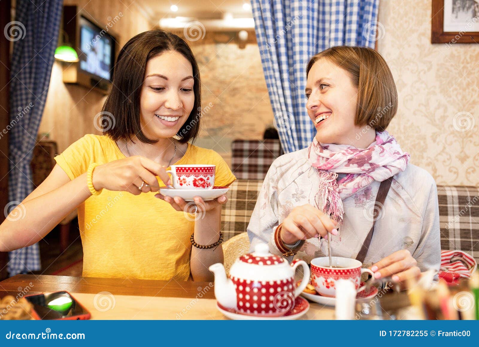 Talking and Laughing while Having Cup of Tea in Cafe Stock Image ...