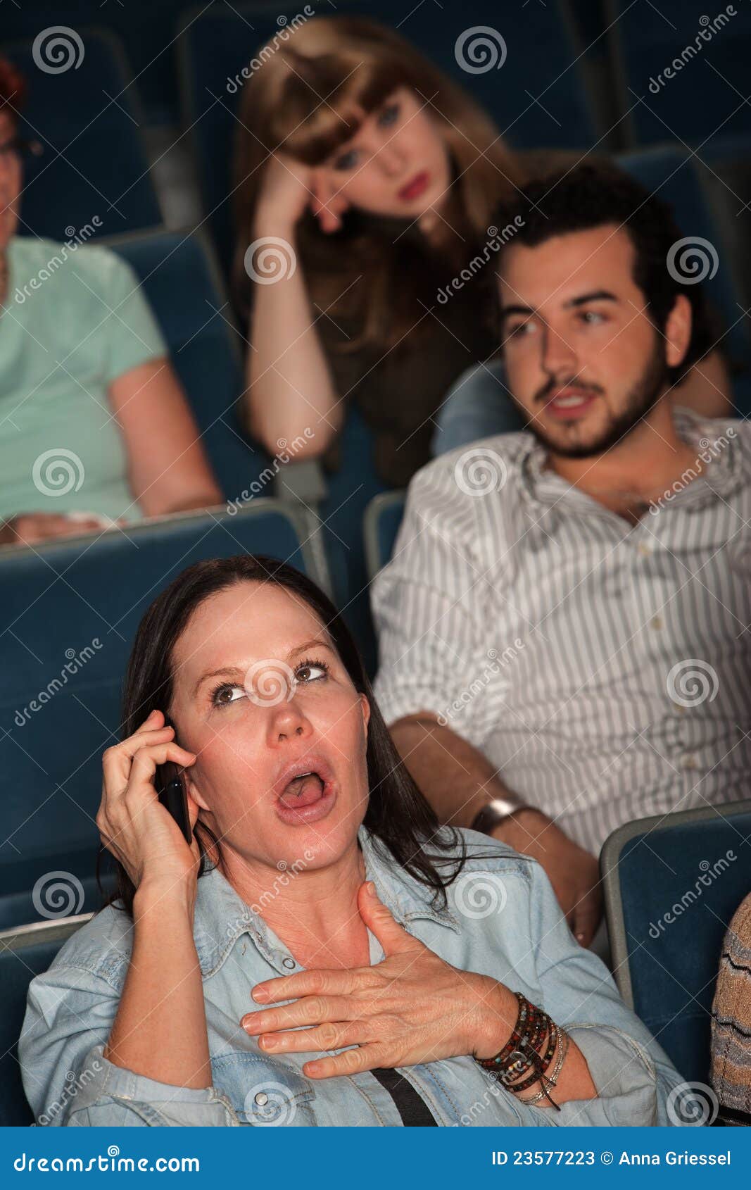 Talking Loudly in a Theater Stock Image - Image of mature, rude: 23577223