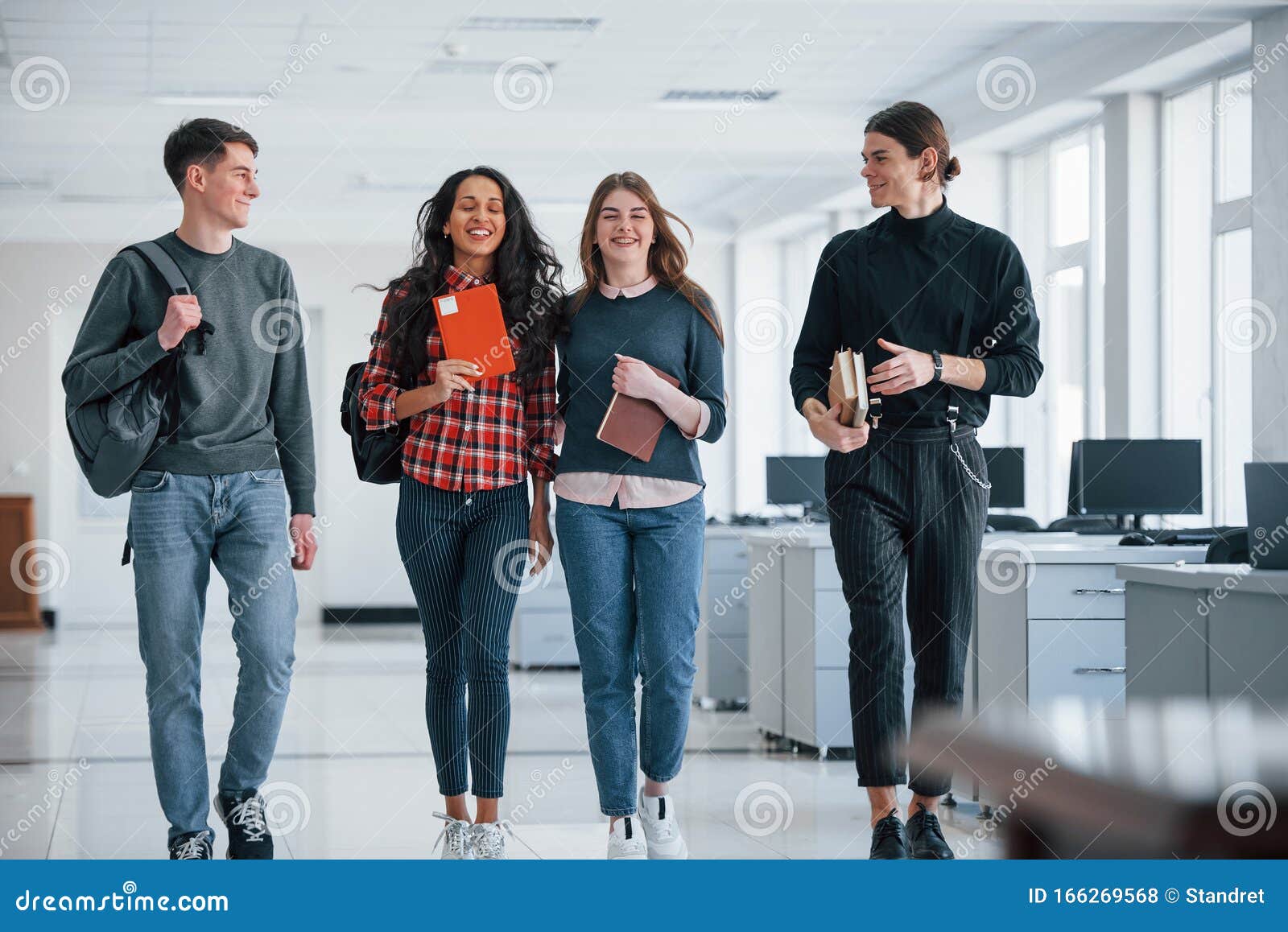 Talking and Smiling. Group of Young People Walking in the Office at ...