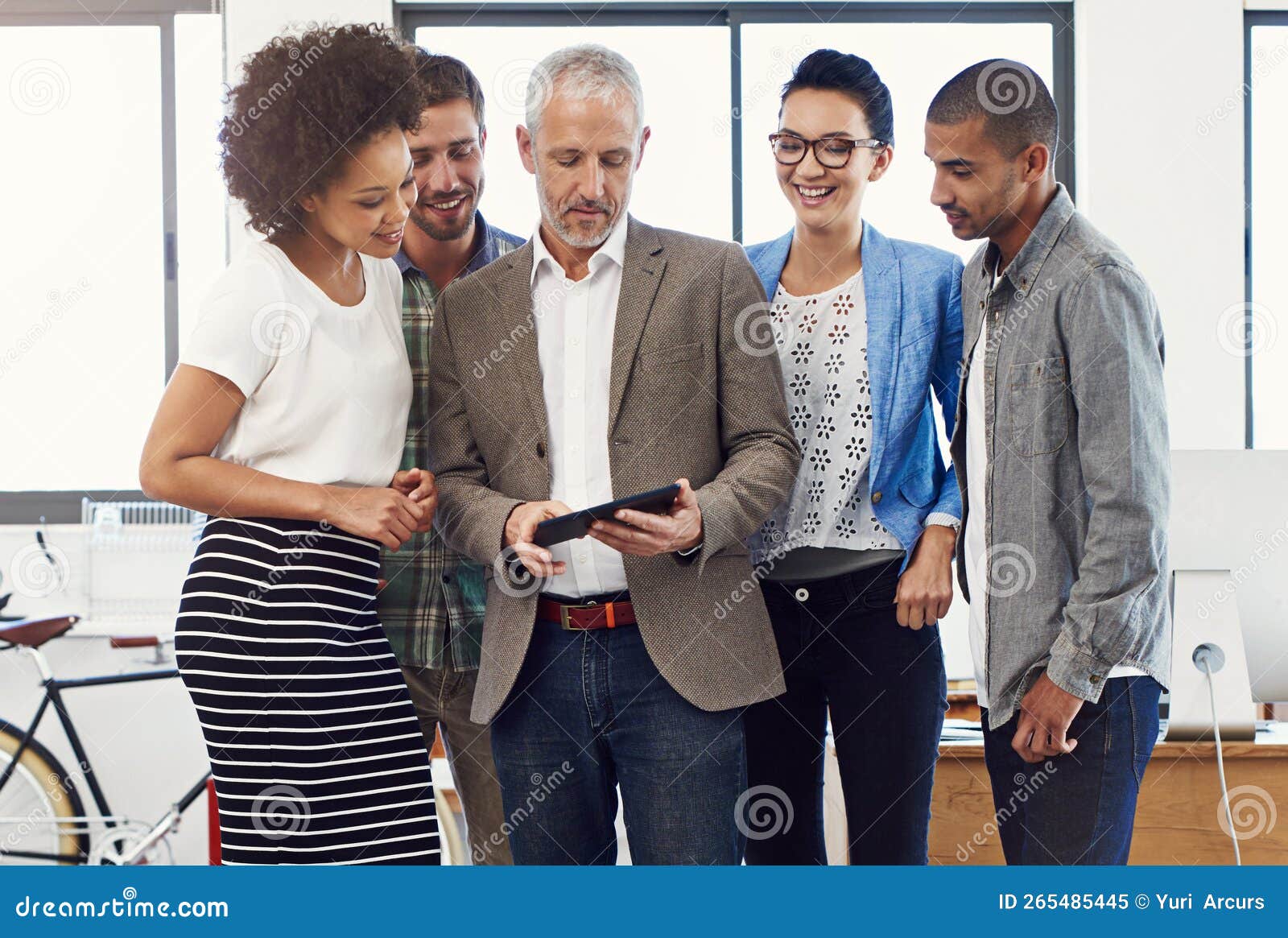 Talking Tech with the Team. a Group of Designers Talking Together Over ...