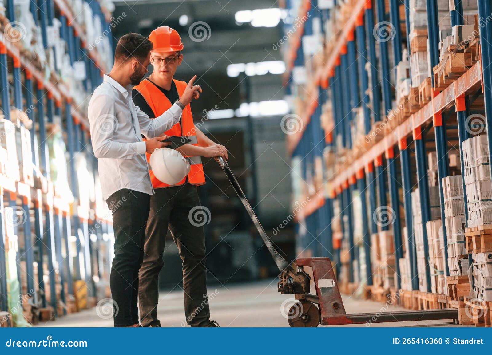 Talking To Each Other. Two Storage Workers is in the Warehouse Stock ...