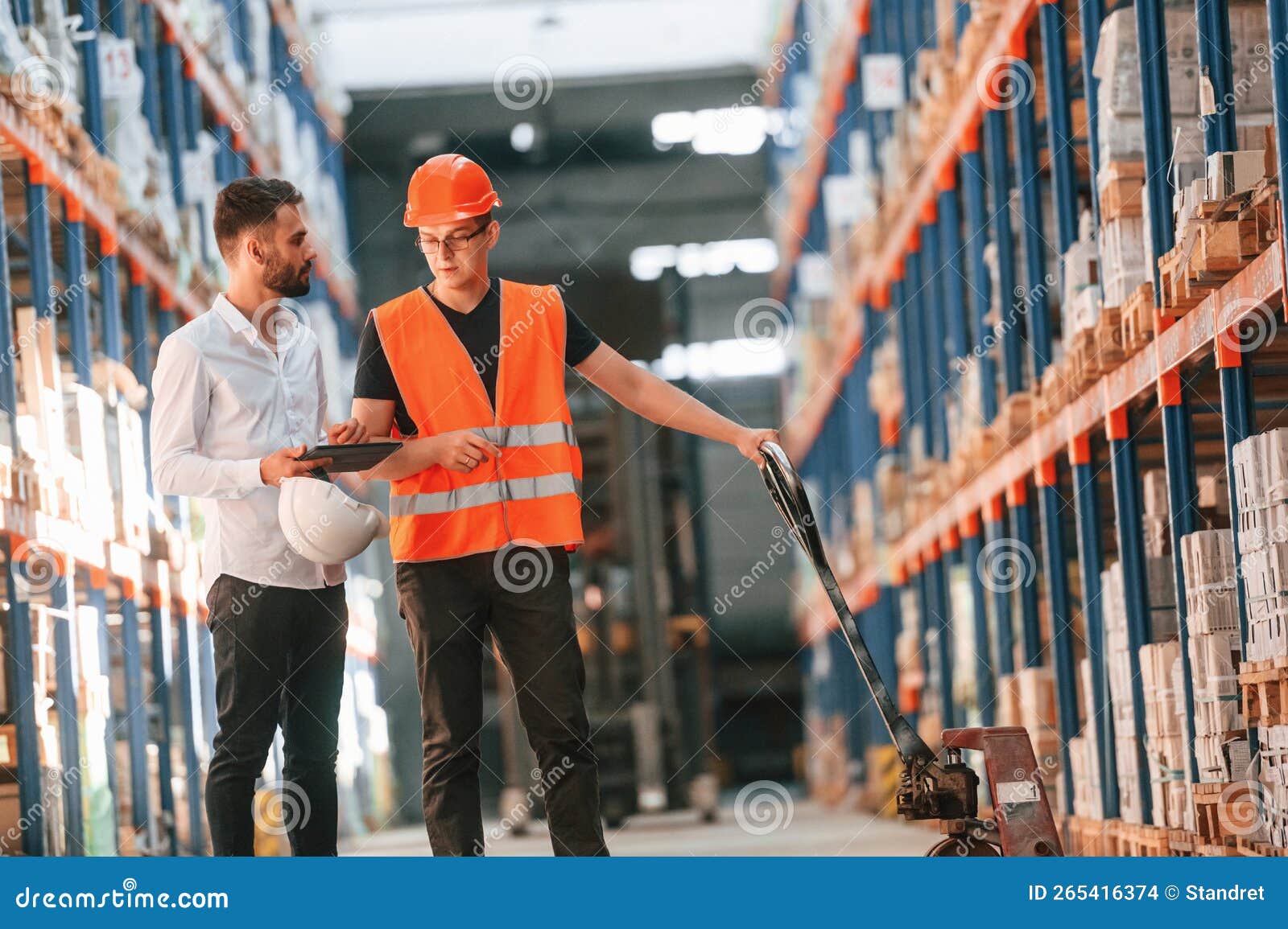 Talking To Each Other. Two Storage Workers is in the Warehouse Stock ...