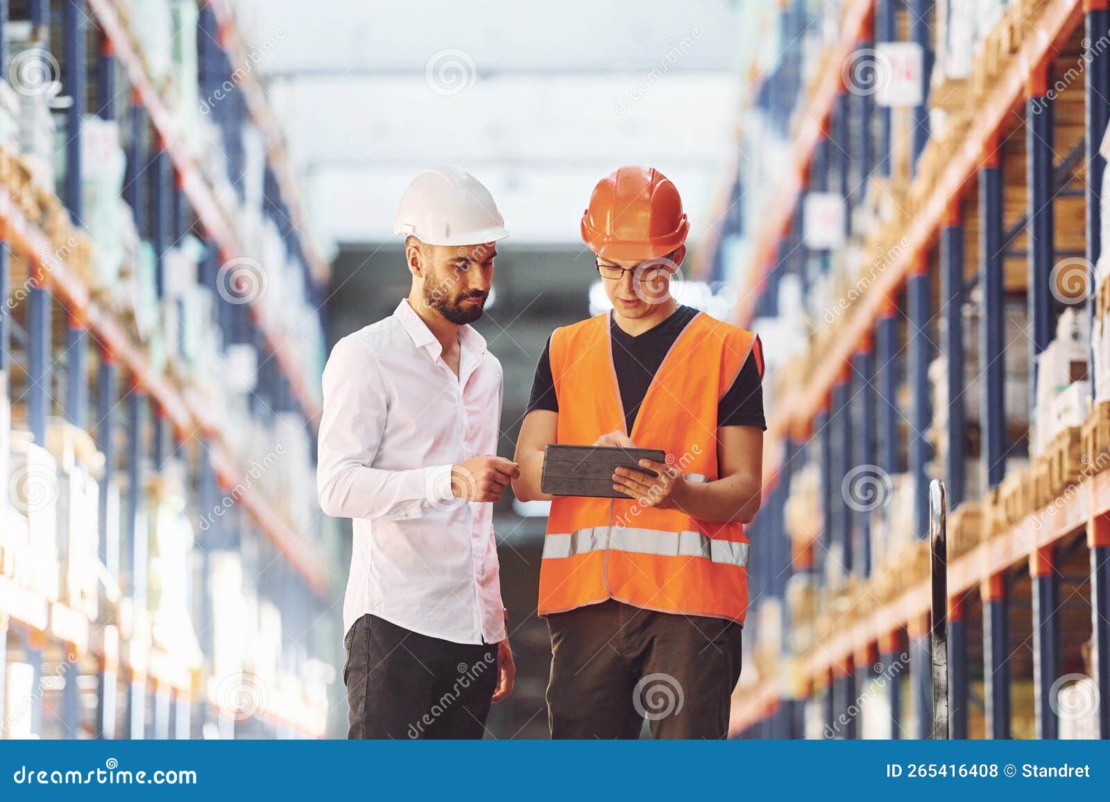 Talking To Each Other. Two Storage Workers is in the Warehouse Stock ...